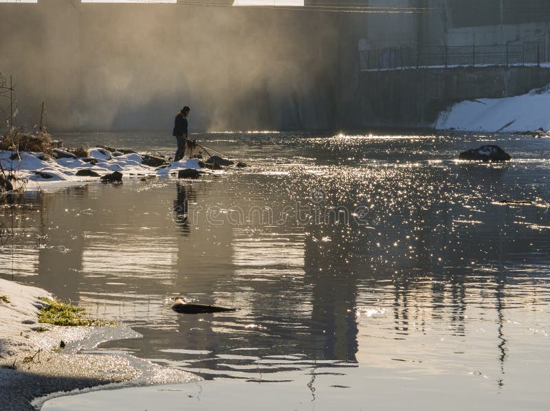Man fishing at the dam stock photo. Image of winter, river - 46885130