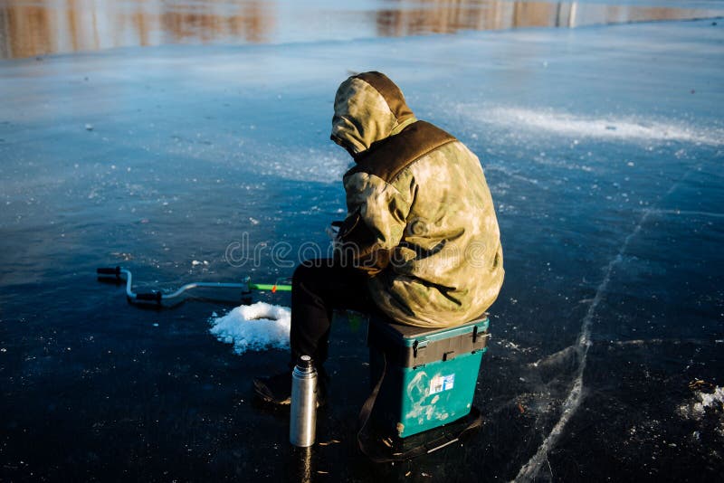 A Man is Fishing on the Ice in the Winter Stock Image - Image of frozen ...