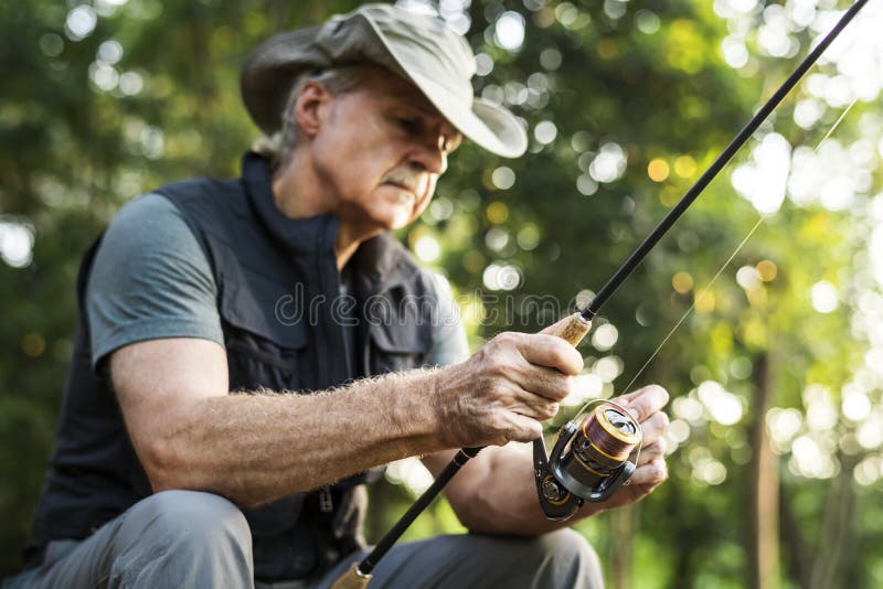 Man fishing by a lake stock photo. Image of marsh, fisherman - 118911226