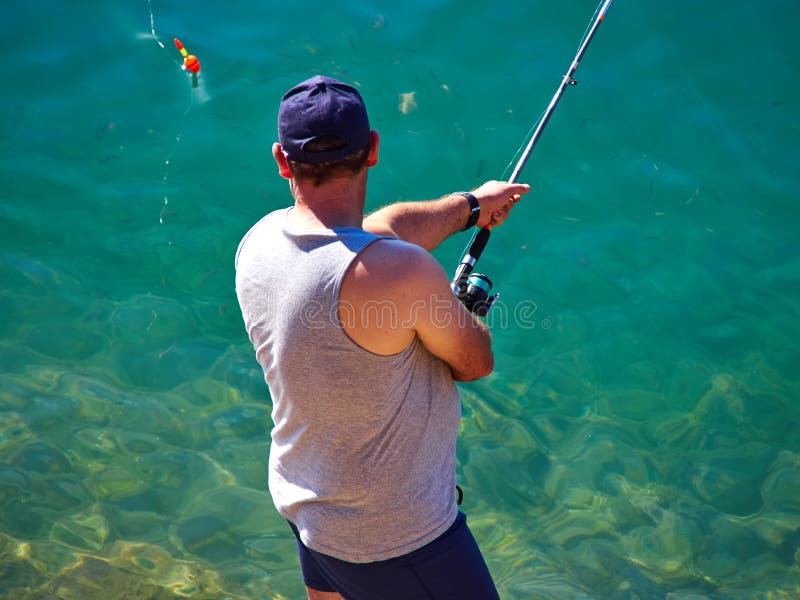 Man fishing by the ocean editorial stock image. Image of bait - 98234084