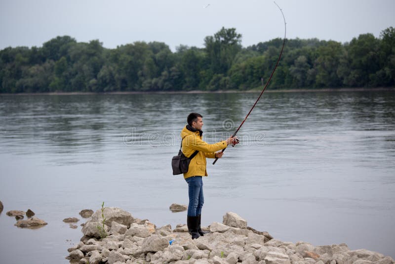 Man fishing on river coast stock image. Image of casting - 185073849