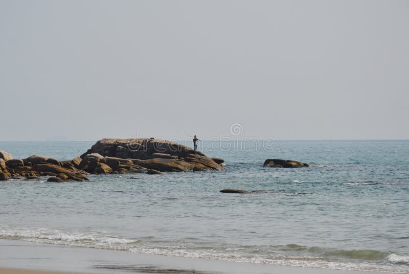 Man Fishing on Rock at Beach Stock Photo - Image of outdoor, cape: 81151220