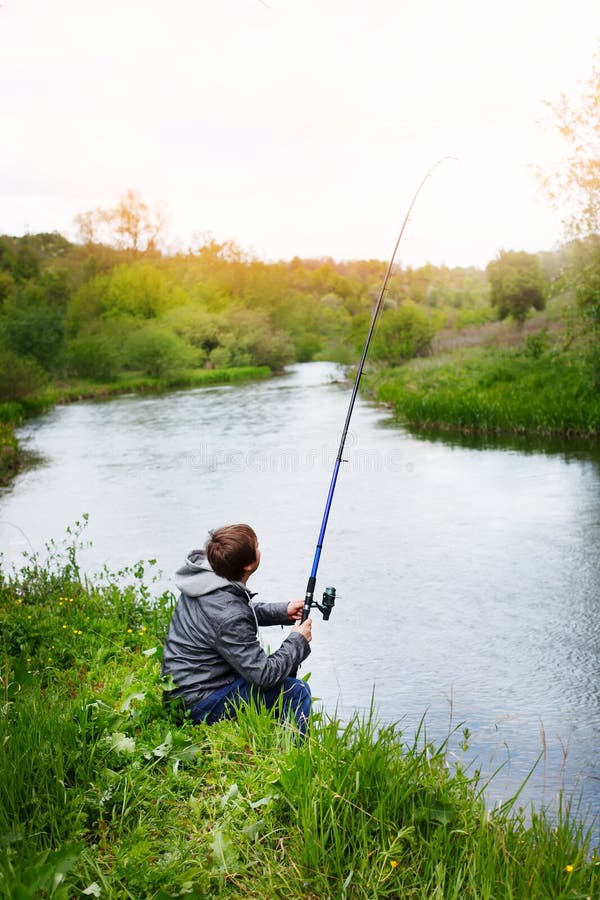 Man with Fishing Rod on the Shore of River Stock Photo - Image of ...