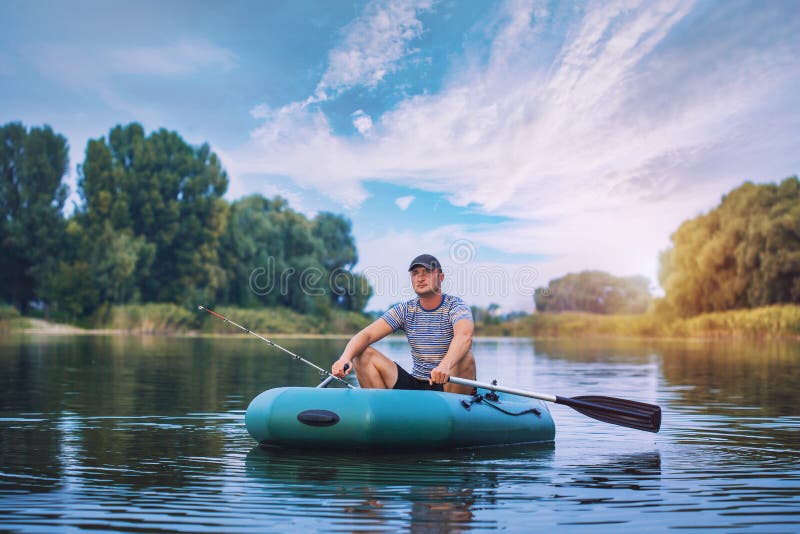 Man Fishing from the Rubber Boat on the Pond Stock Photo - Image of ...