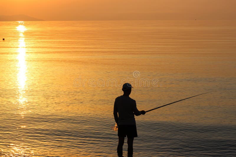 Man Fishing Alone in the Sea at Sunrise or Sunset Editorial Photography ...