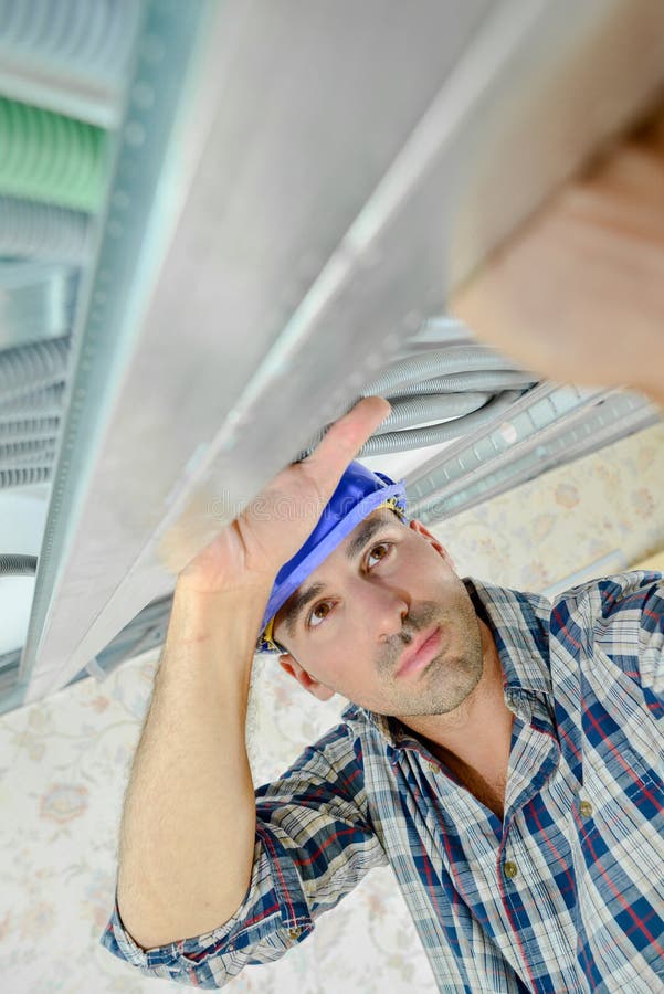 Man Fitting Ceiling at Work Stock Photo - Image of trade, tubes: 152586110