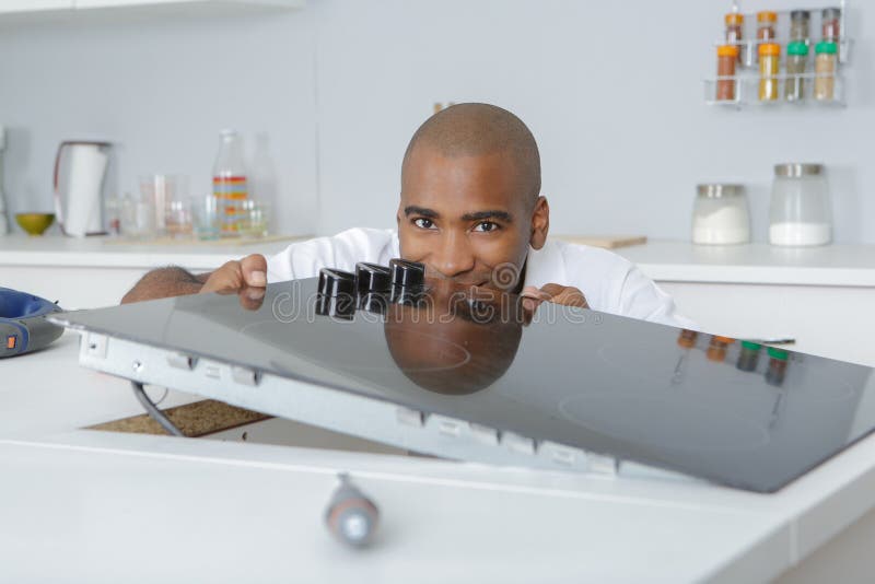 Man fitting a hob stock image. Image of work, insert - 150199395