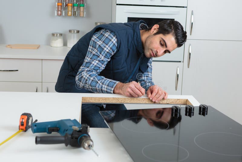 Man fitting hob stock image. Image of size, technician - 280479143