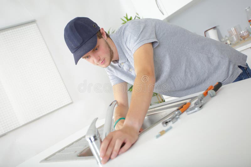 Man fitting kitchen tap stock photo. Image of handtools - 132201824