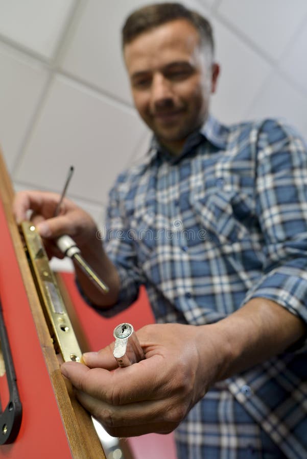 Man fitting new door lock stock photo. Image of male - 104146354