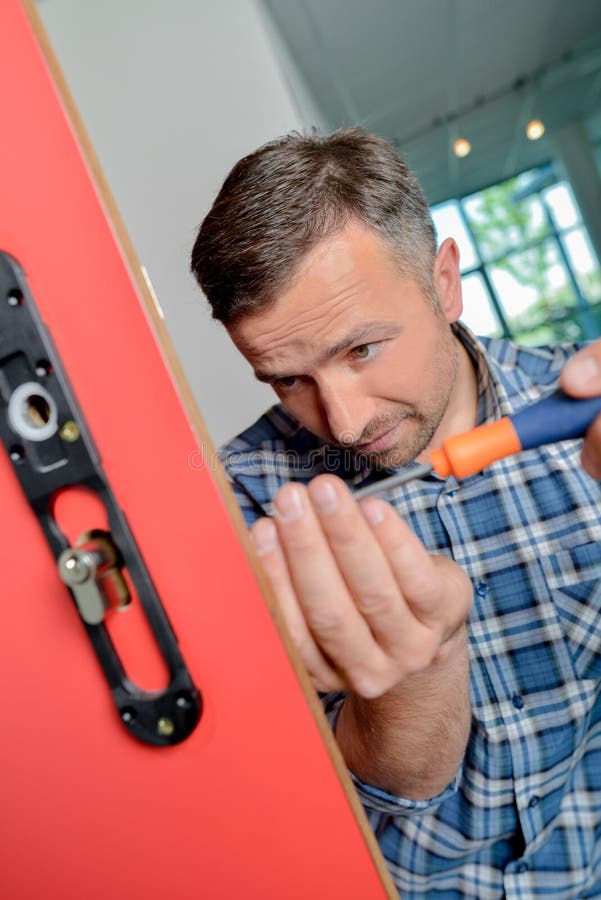 113 Man Fixing Lock To Door Stock Photos - Free & Royalty-Free Stock ...
