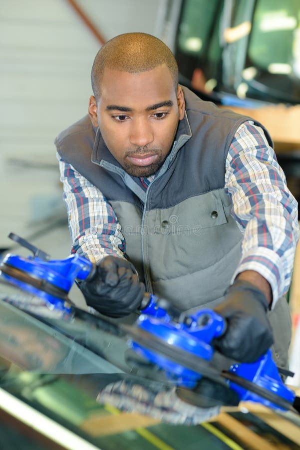Man fitting new windshield stock image. Image of diversity - 121670913