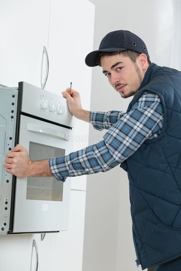 Man Fitting Oven in Kitchen Stock Image - Image of person, construction ...
