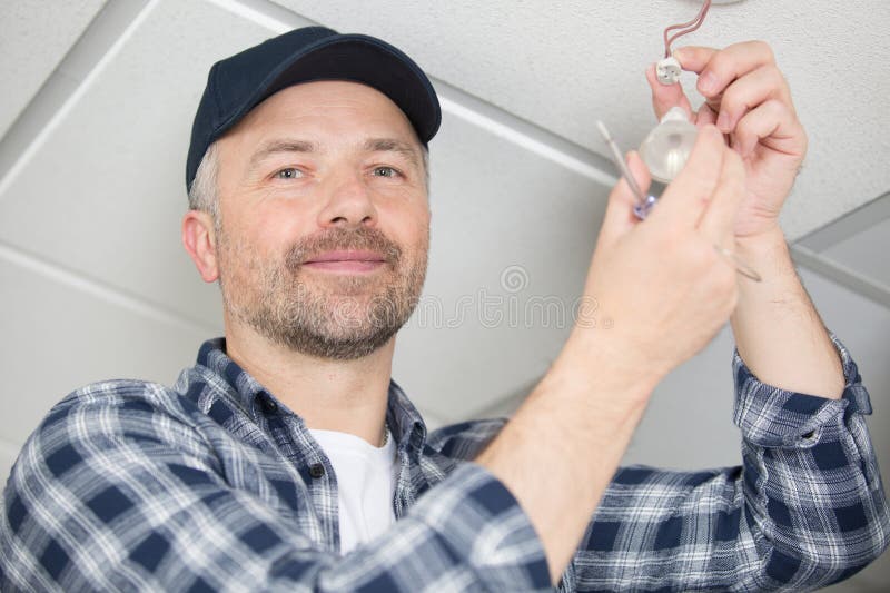 Man Fitting Replacement Spotlight Bulb Stock Photo - Image of ...