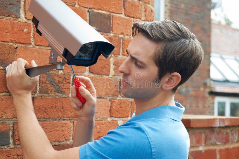 Man Fitting Security Camera To House Wall Stock Image - Image of ...