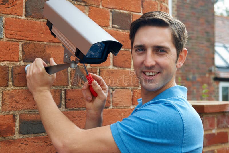 Man Fitting Security Camera To House Stock Image - Image of security ...