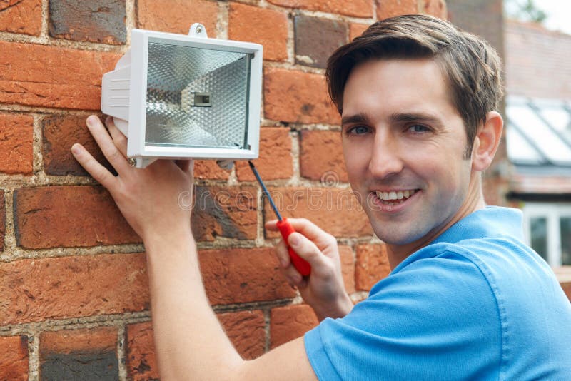 Man Fitting Security Camera To House Wall Stock Image - Image of ...