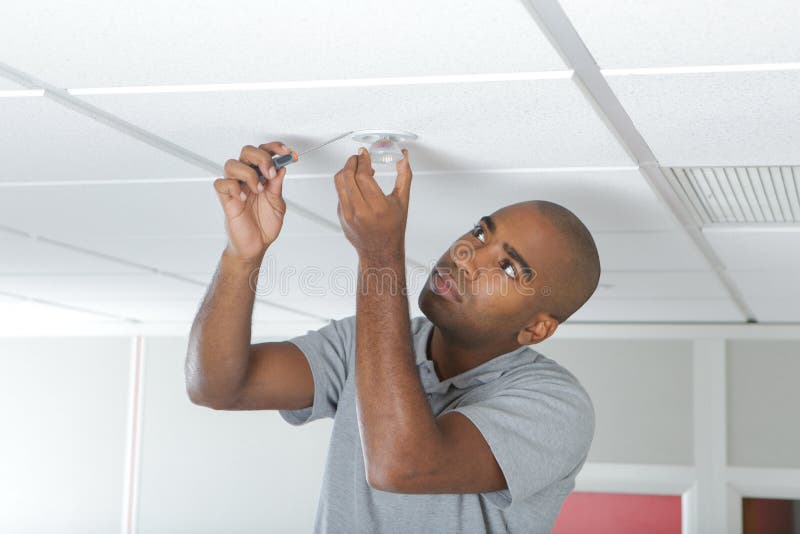 Man Fitting Spotlight To Ceiling Stock Image - Image of working, home ...