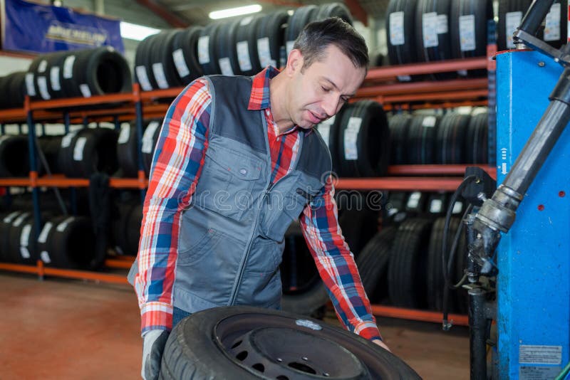 Man Fitting Tyre with Impact Screwdriver Stock Photo - Image of garage ...