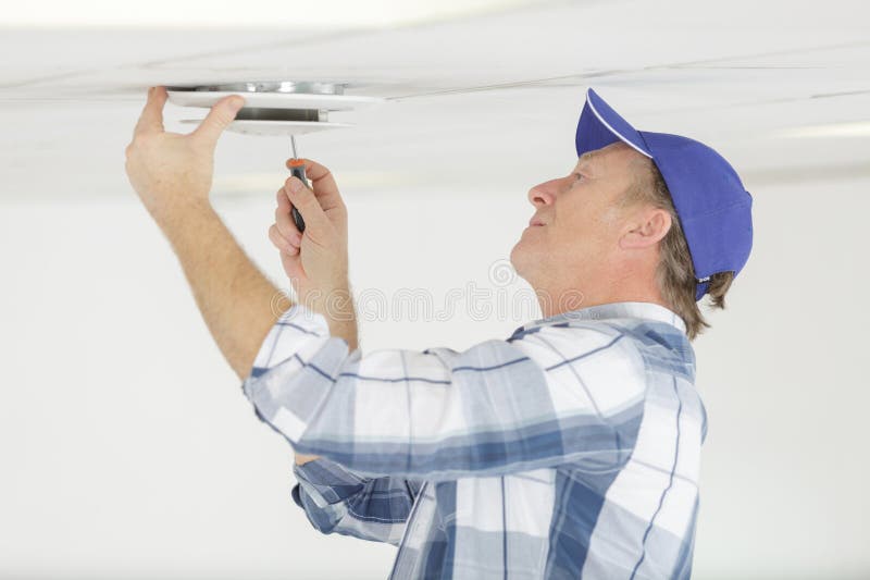 Man fixes ceiling skirting stock image. Image of repairing - 336982041