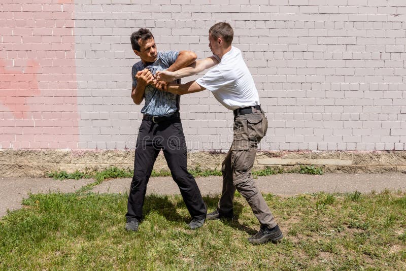 The Man Fixes the Hands of the Attacker, while Striking with the Elbow ...