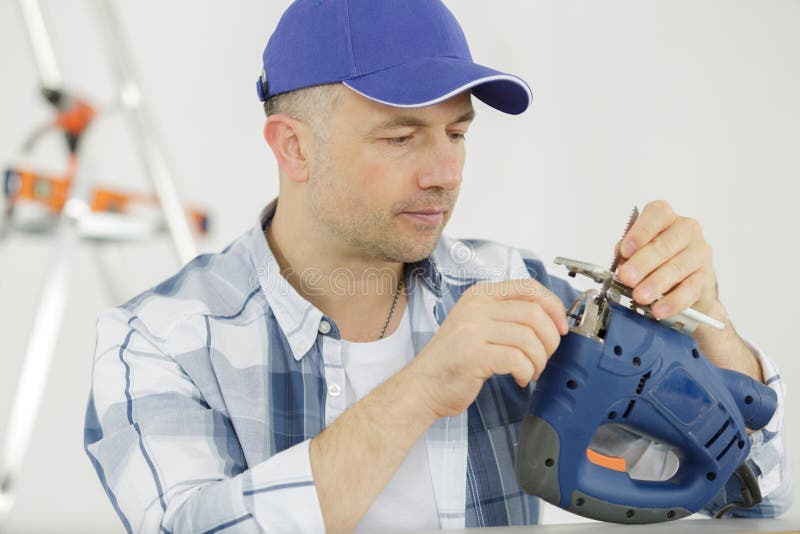 Man Fixing Blade in Electric Jigsaw Tool Stock Image - Image of ...
