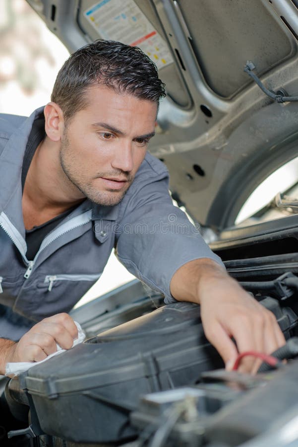 Man fixing car engine stock image. Image of people, check - 83390851