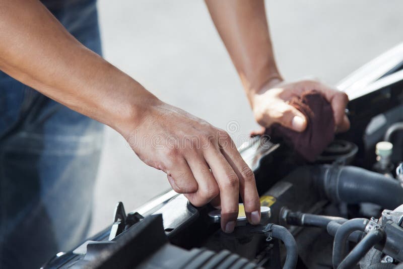 Man fixing a car stock photo. Image of closeup, examining - 182791946