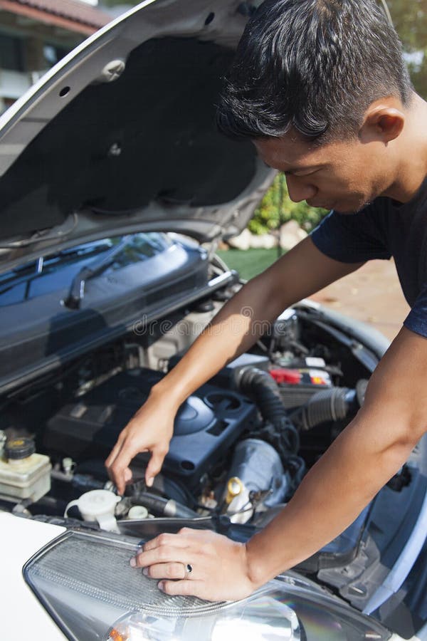Man fixing a car stock photo. Image of fixing, inspecting - 183292848