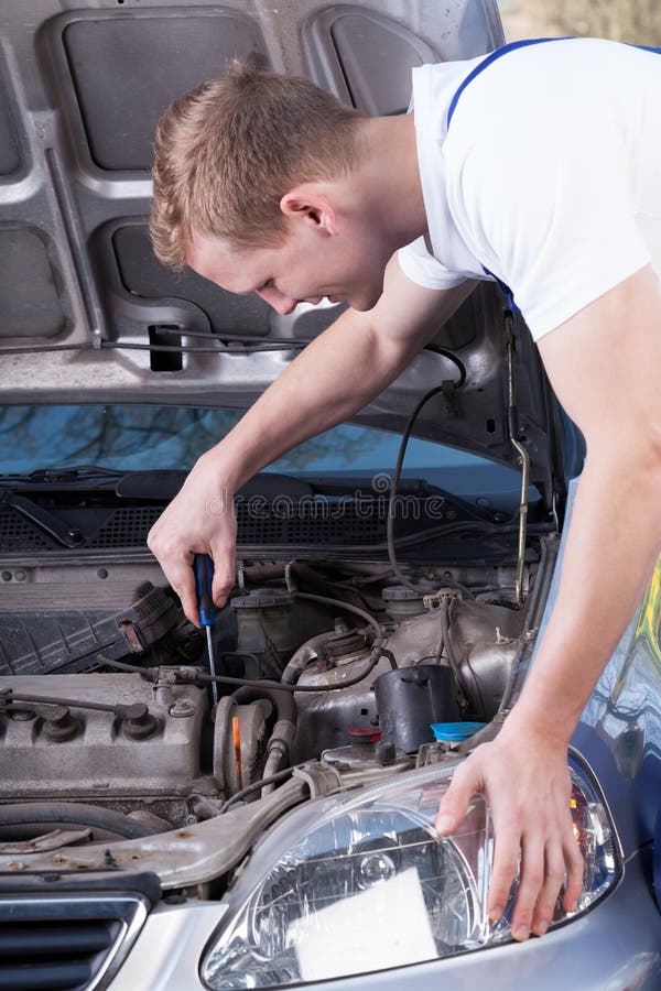 Man fixing a car stock photo. Image of screwdriver, open - 41575934