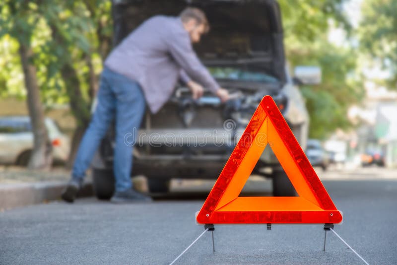 Man Fixing Car on Road. Car Breakdown while Driving. Driver Looks on ...