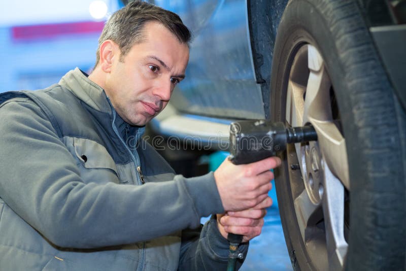 Man fixing car wheel stock photo. Image of tyre, people - 148695796