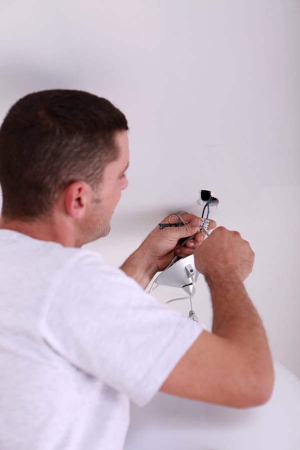 Man fixing ceiling light stock image. Image of skill - 36895733