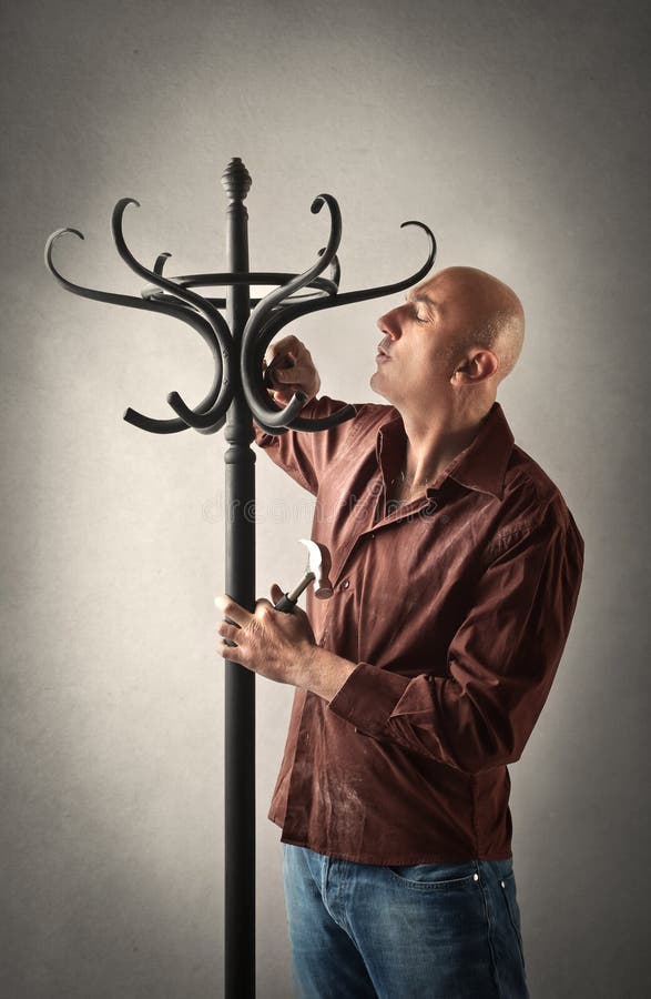 Man fixing coat rack stock photo. Image of rack, wall - 67499104
