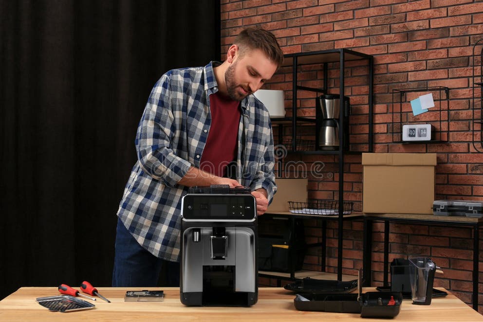 Man Fixing Coffee Machine at Table Indoors Stock Image - Image of ...