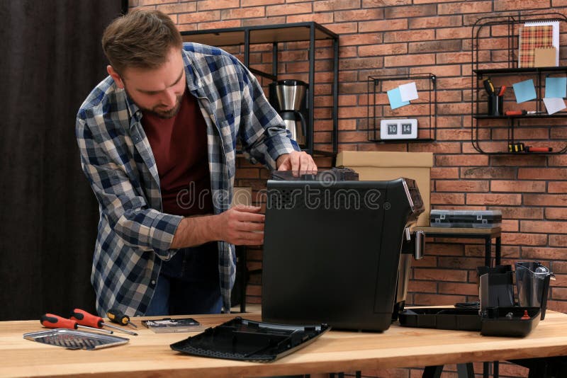 Man Fixing Coffee Machine at Table Indoors Stock Photo - Image of ...