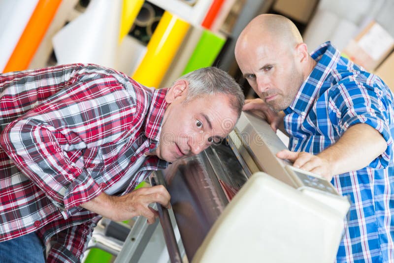 Man fixing cutting machine stock image. Image of fixing - 95336427