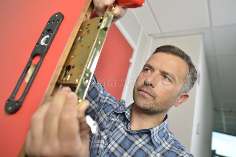 Man fixing door stock photo. Image of tool, vocational - 288845324