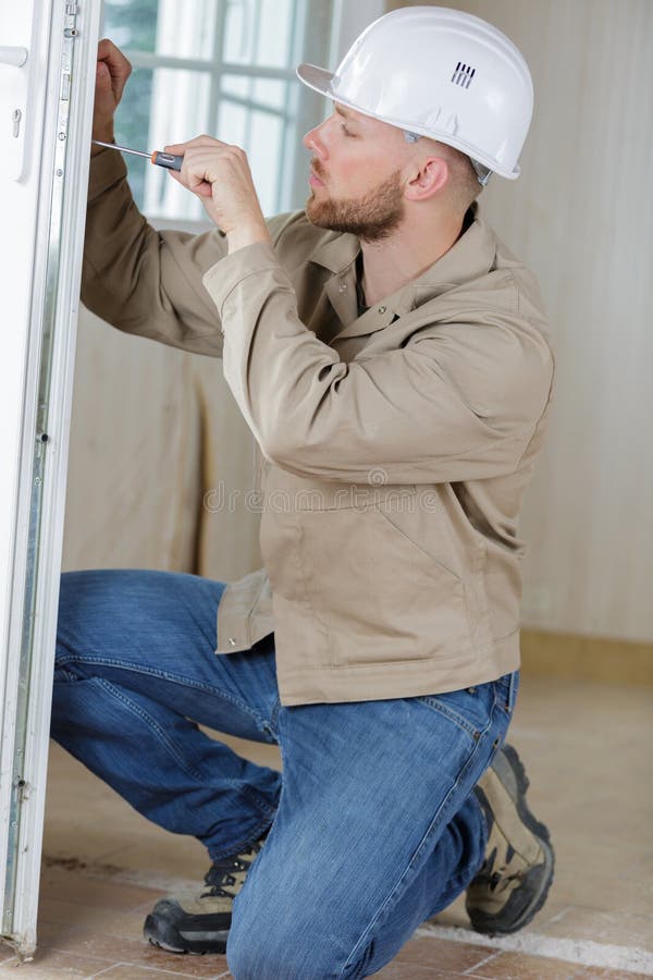 Man fixing door stock photo. Image of technician, maintenance - 296371722