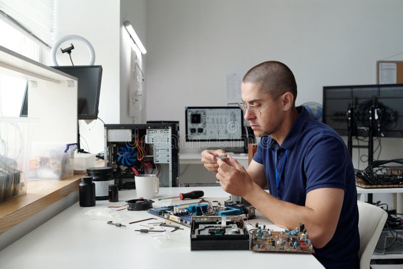 Man Fixing Electronic Device at Workbench Desk Stock Photo - Image of ...