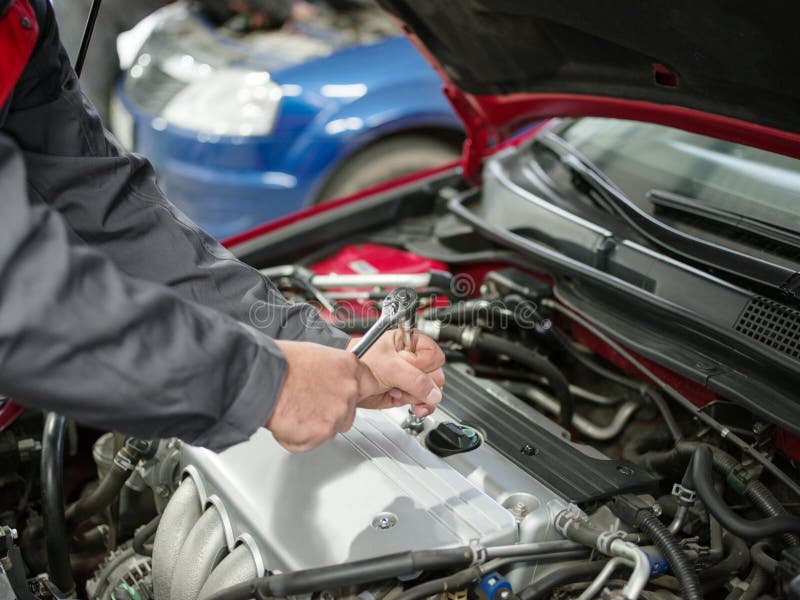 The Man is Fixing the Engine. Stock Image - Image of brunette, disks ...
