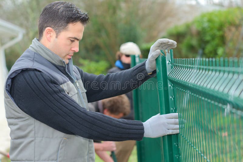 Man fixing fencing stock image. Image of steel, frame - 326319241