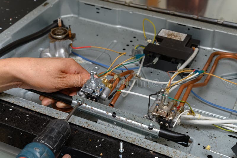 Man fixing gas cooker stock photo. Image of screwdriver - 190499538