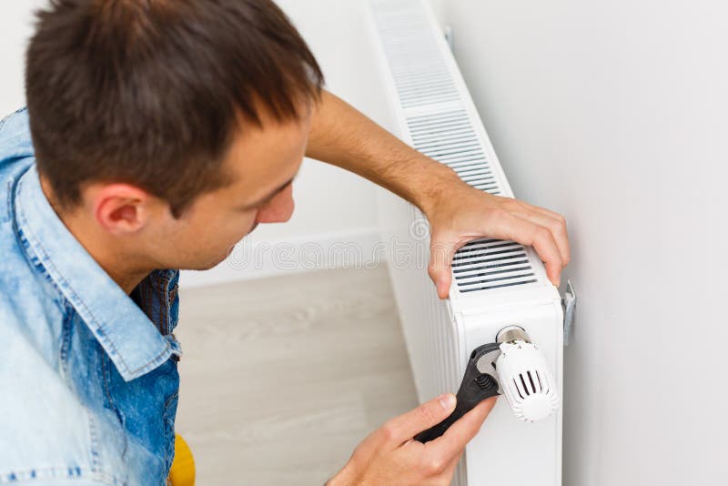 Man Fixing a Heating Radiator Stock Image - Image of pipe, control ...