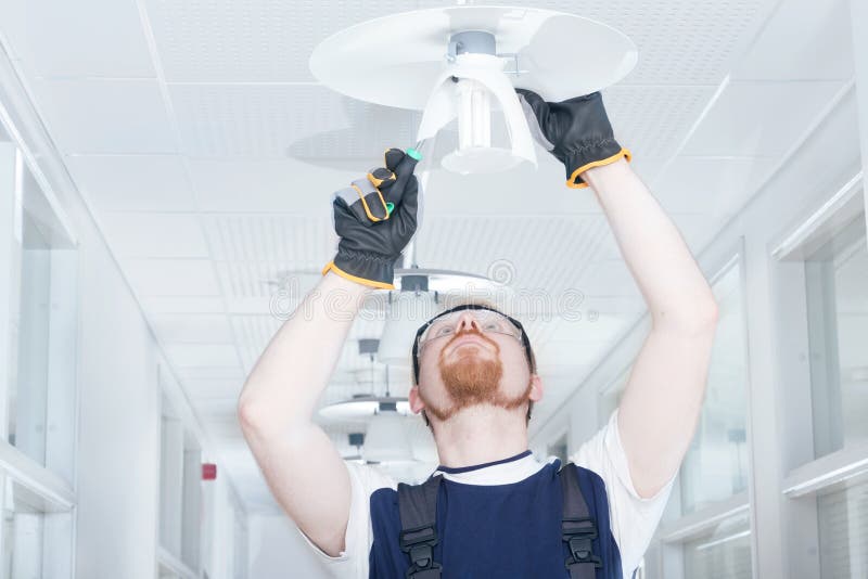 Janitor Fixing Broken Lamp stock image. Image of light - 31386591