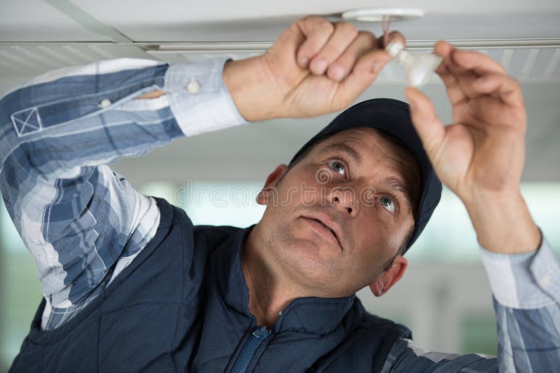 Fixing a Light Fixture stock image. Image of household - 6295567