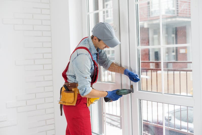 Man Fixing Lock To Window with Electric Screwdriver Stock Image - Image ...