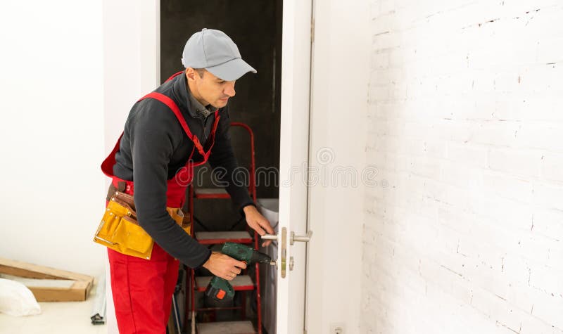 Man Fixing Locks with Screwdriver in a New House Stock Image - Image of ...