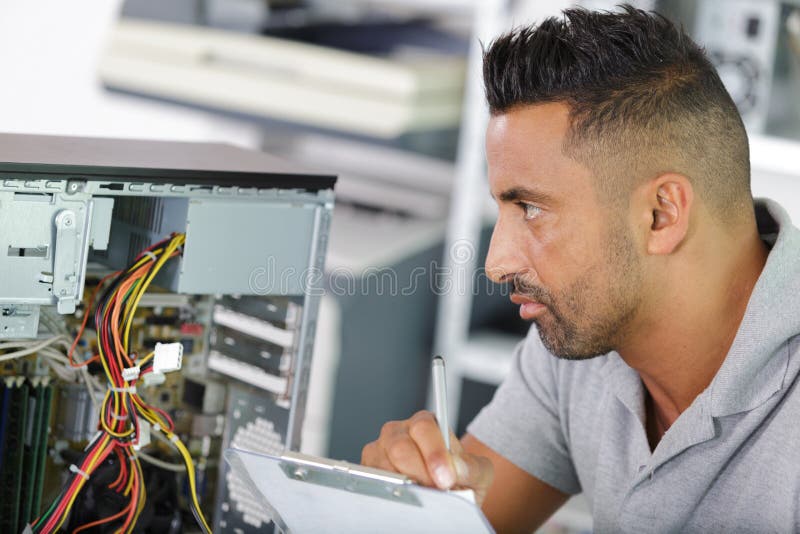 Man fixing a machine stock photo. Image of clipboard - 150570470