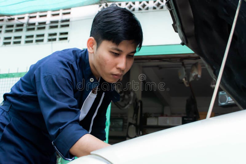 A Man is Fixing Machine in Automotive Service Center Stock Image ...